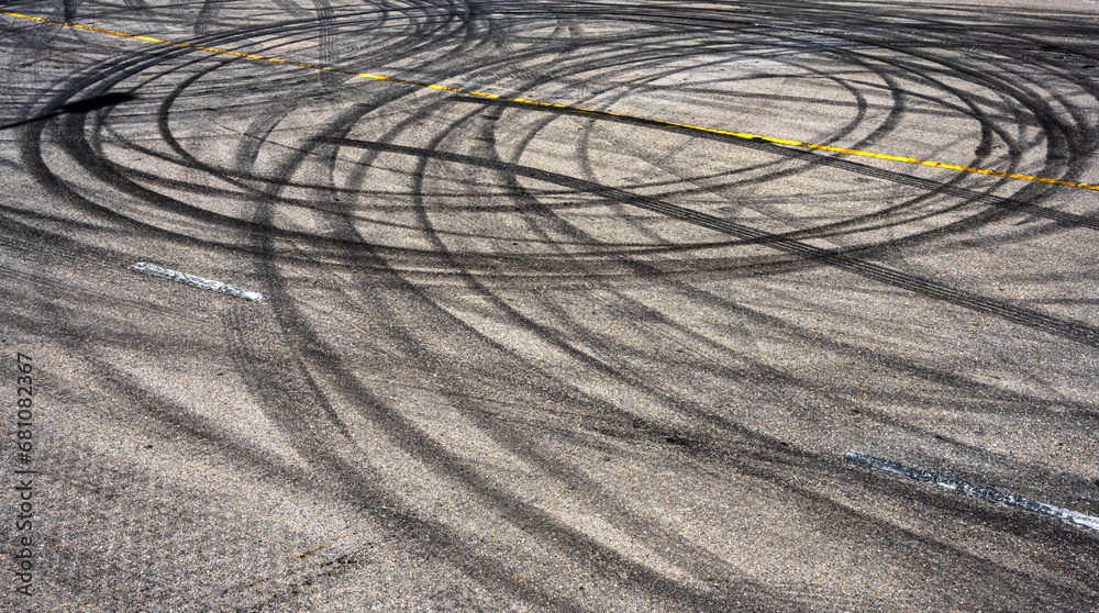Top view curving tire marks from professional car drifting on asphalt racing track, aerial view ...