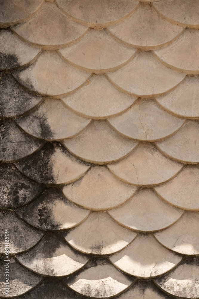 Close-up shot of a wall designed to resemble fish scales. Concrete ...