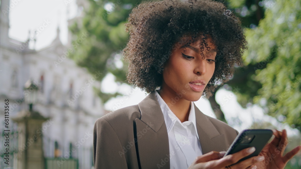 Gorgeous woman typing smartphone outdoors in suit close up. Girl using ...