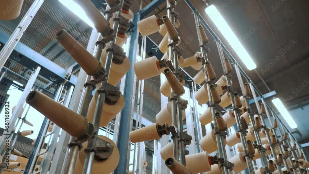 thread spools. textile industry. weaving factory. racks with many ...