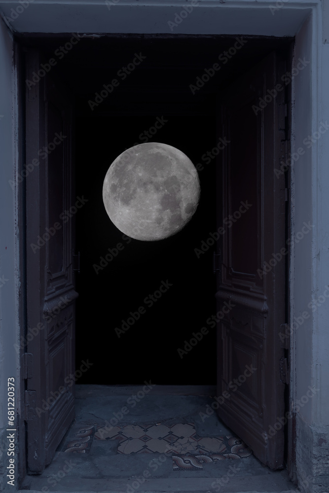 view of the full moon through the open double doors in the entrance ...