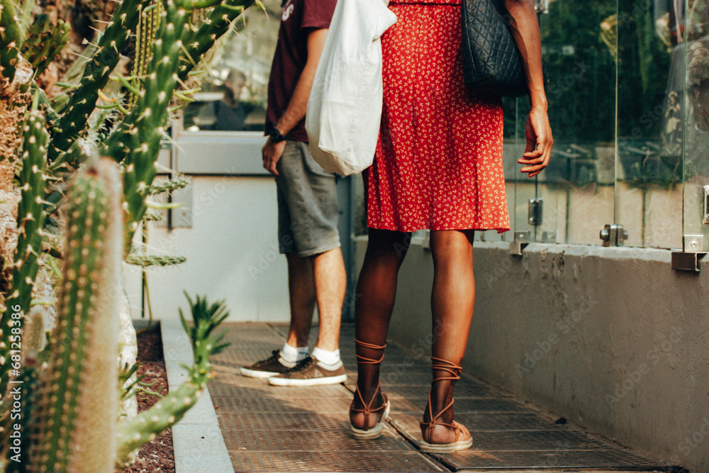 Faceless people walking in botanical garden, greenhouse looking at ...