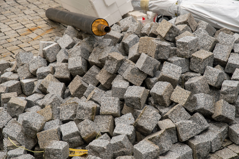 Concrete blocks and supply pipes are ready to be laid on the road at ...