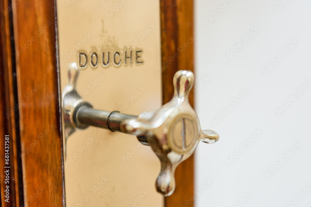 Tap on an old fashioned shower unit labeled "douche" Stock Photo ...