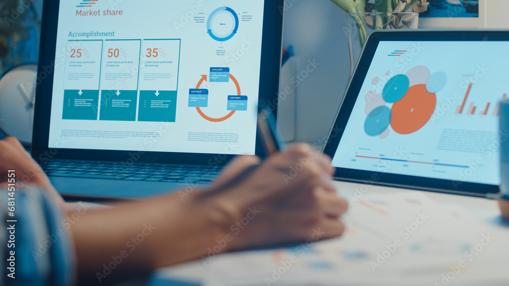 Close-up young asia lady freelance focus on laptop write worksheet ...