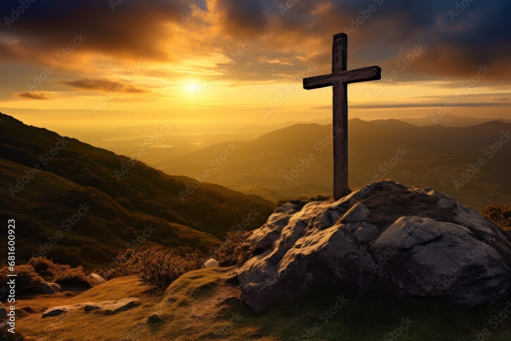 a cross sitting on top of a large rock in the middle of a grassy field ...