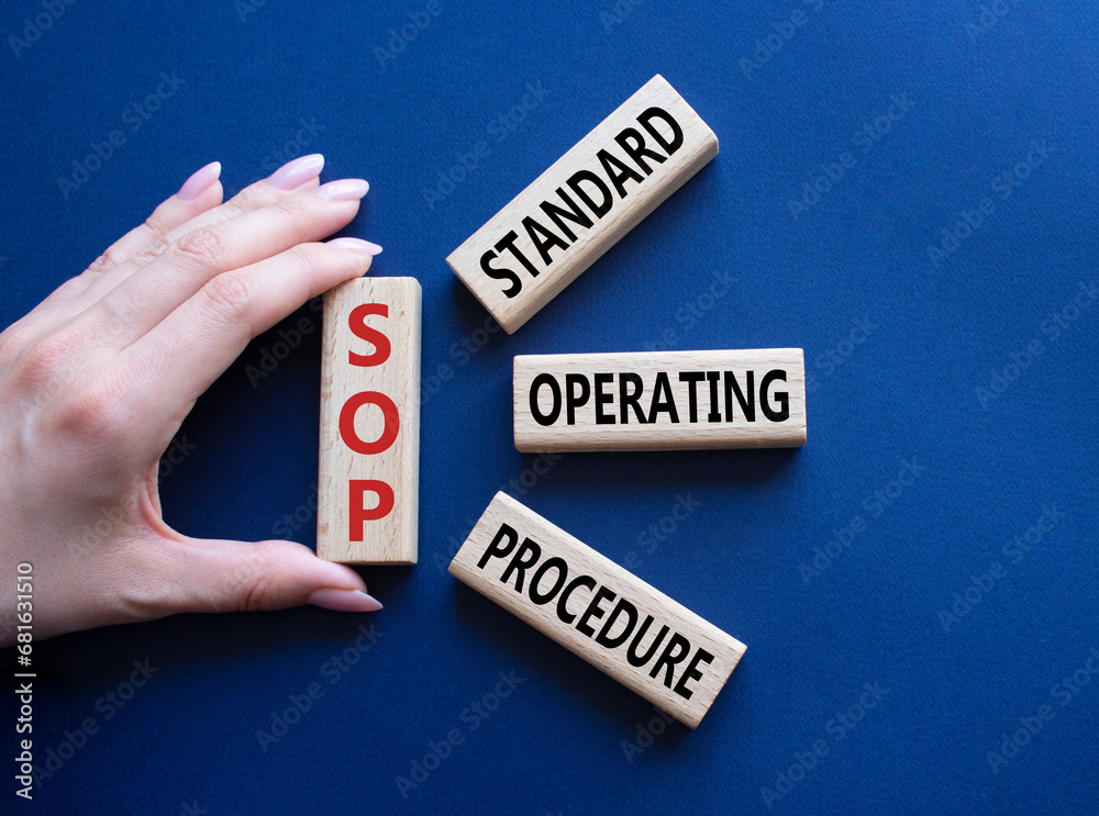 SOP - Standard Operating Procedure symbol. Wooden blocks with word SLA ...