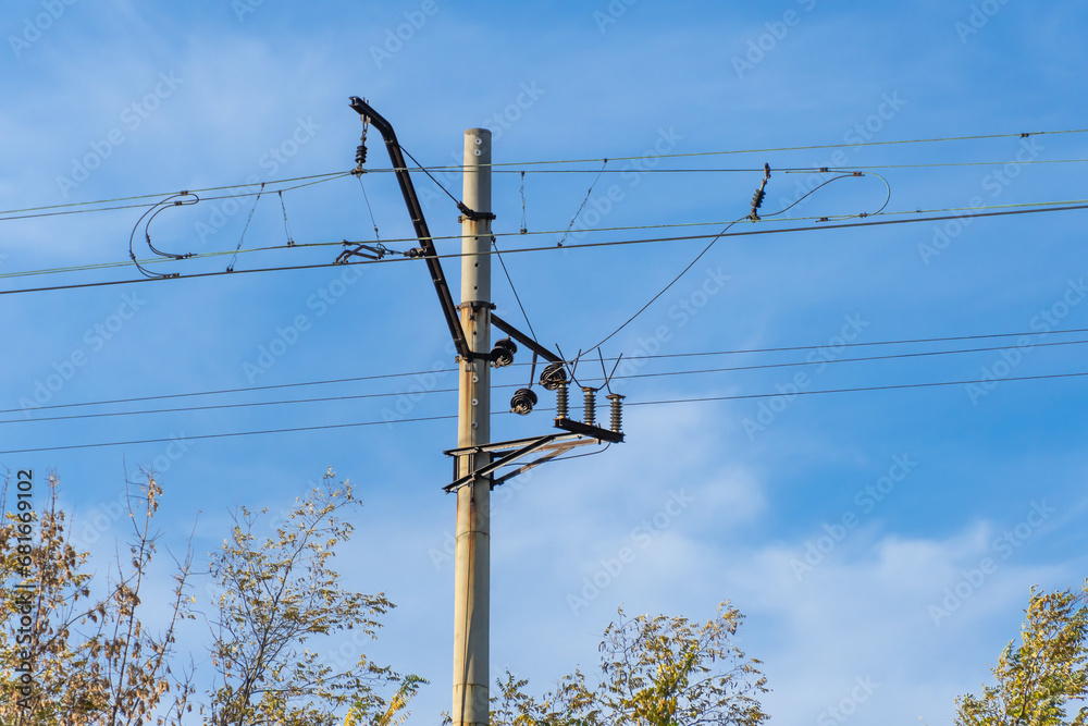 Electrified railway pole on blue sky background. Electric power supply ...