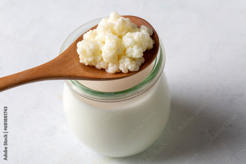 Kefir fermented milk drink with kefir grains. Homemade kefir stands in ...