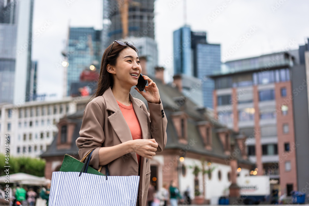 Asian beautiful women talking on phone while walk in department store ...