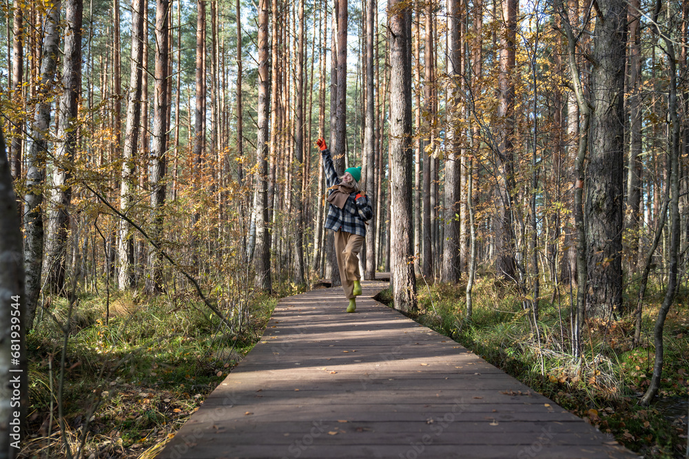 Overjoyed woman walking skipping raising hand rejoicing in autumn ...