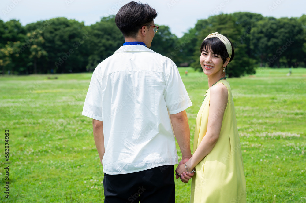 Beautiful Asian woman strolling hand in hand with her lover on the ...