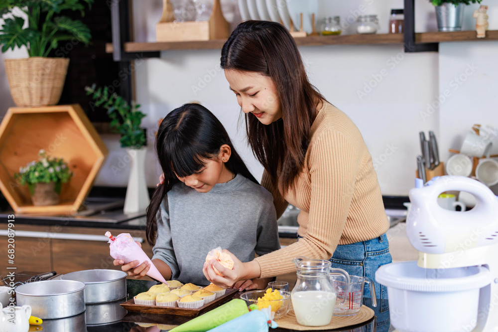 Asian female baker pastry chef mother helping teaching little girl ...