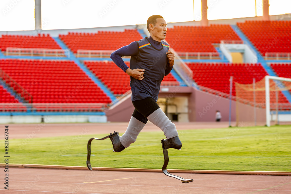 Asian para-athlete with prosthetic blades leg in stadium practicing ...