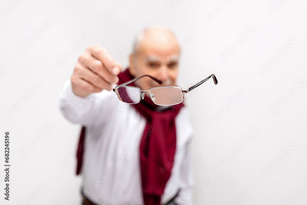 Vision correction and treatment. A mature man throws away his glasses ...