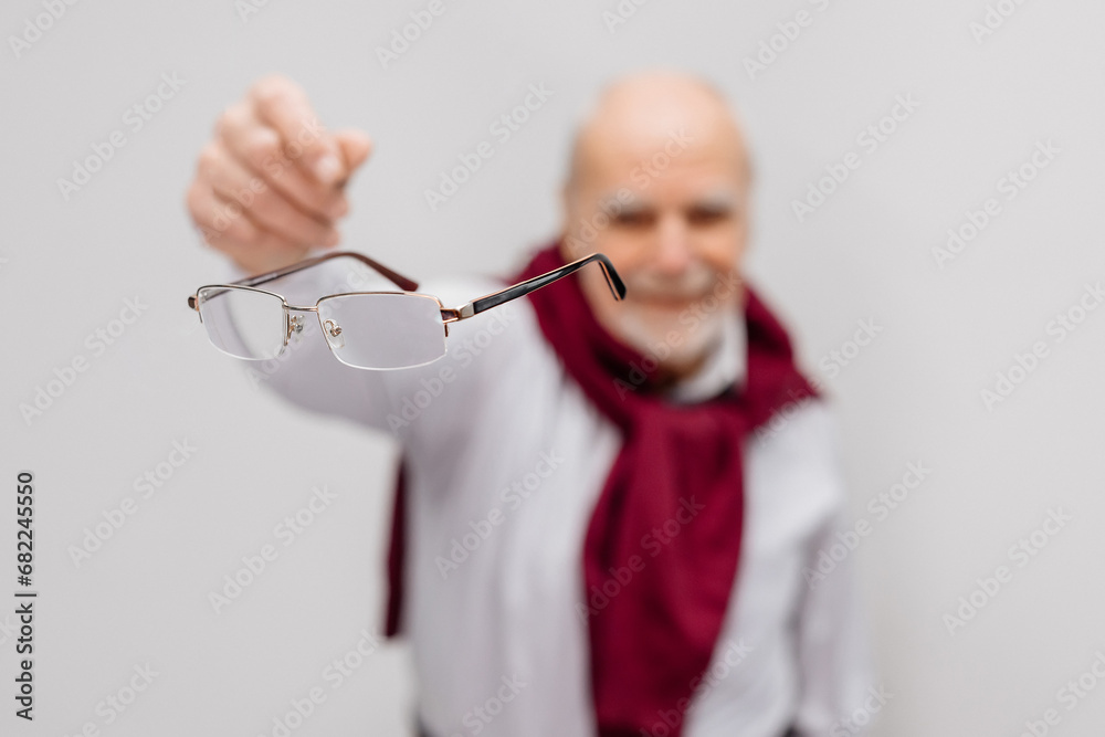 Vision correction and treatment. A mature man throws away his glasses ...