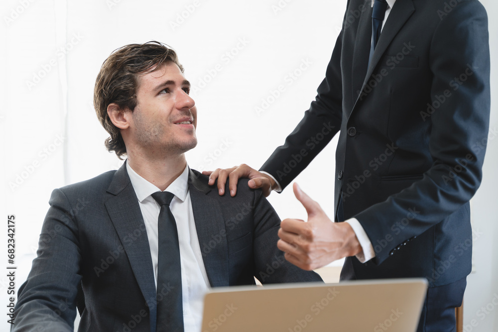 Close up view boss encouraging employee by show thumb up after done ...