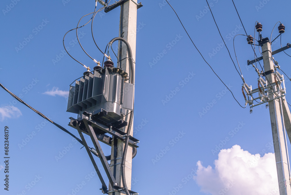 Reinforced concrete pole with electrical utilities next to trees ...