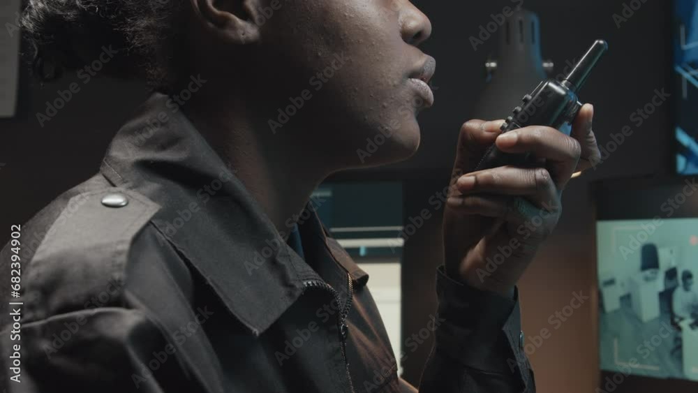 Tilt cropped shot of unrecognizable African American female security ...