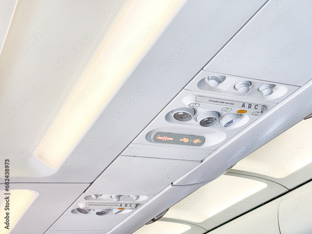 The cabin ceiling of the plane with AC control dial, reading lamp light ...
