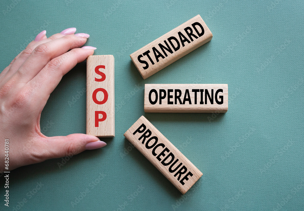 SOP - Standard Operating Procedure symbol. Wooden blocks with word SLA ...