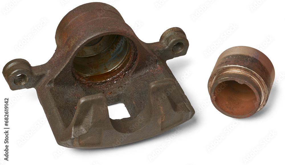 old disc brake caliper and piston, rusty and worn out components in the ...