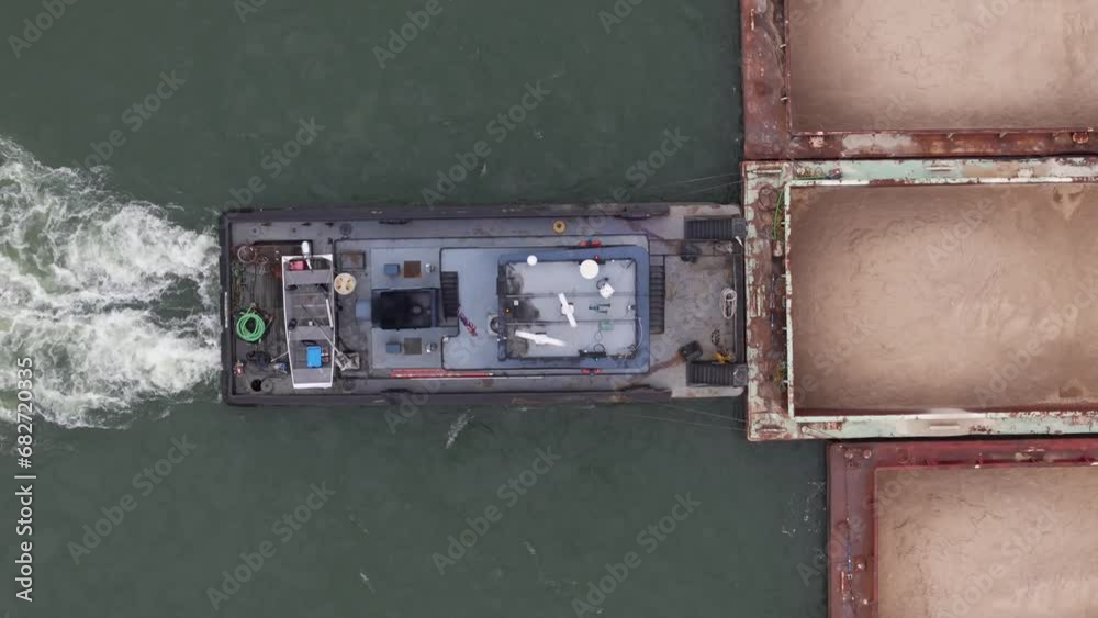 Tow boat pushing hopper barge on Ohio river, top down close up of ...