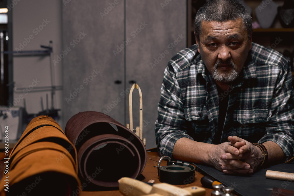 successful craftsman with crossed fingers, hands posing to the camera ...