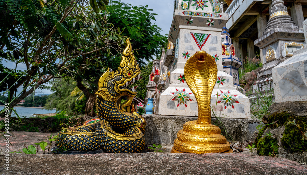 Snake sculptures in a Buddhist cemetery at the Wat Sila Ngu temple in ...