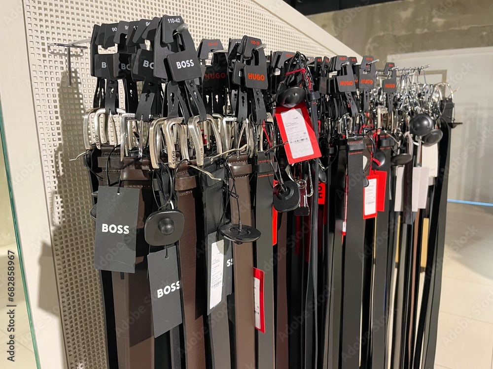 Belts from famous brand Hugo Boss on rack in sales area. Section of ...