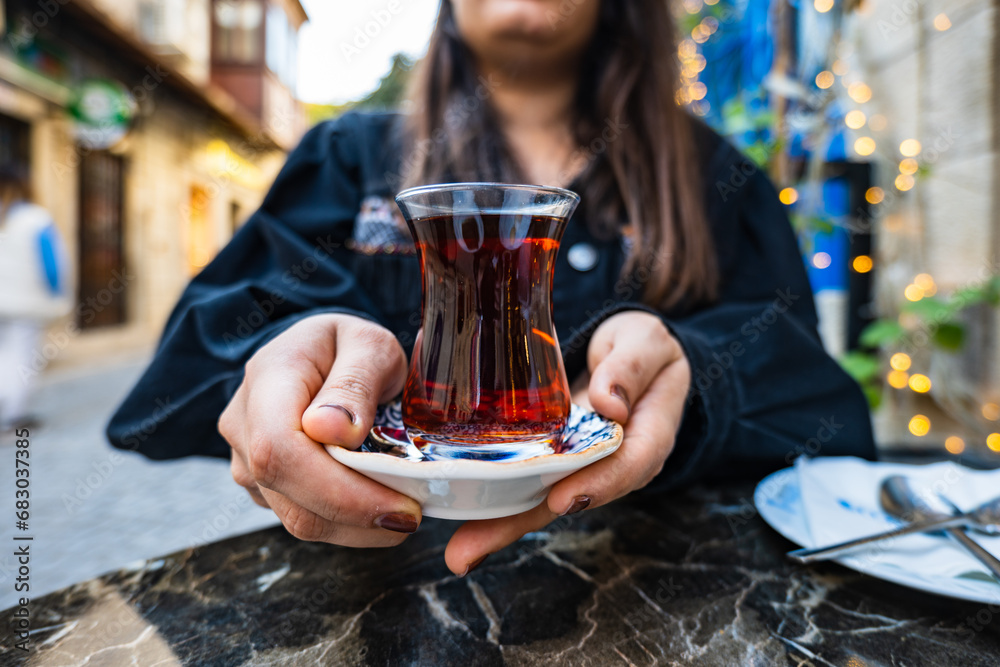 Turkish Tea in traditional tea glass and saucer in Turkey, street ...