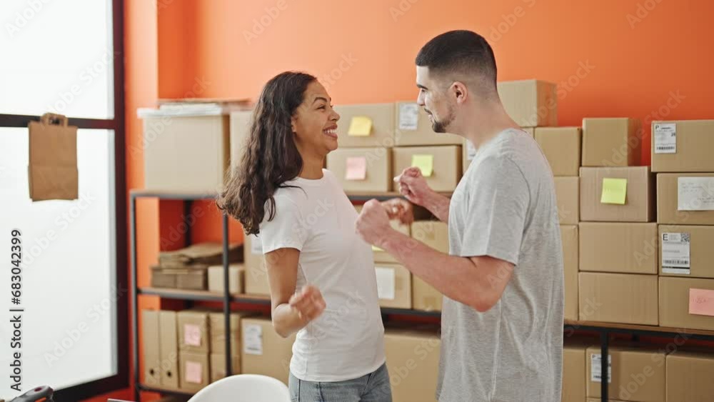 Ecstatic man and woman workers, part of a dynamic team, celebrating ...