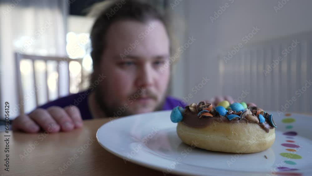 Person wanting to eat sugar food on plate. Young overweight man in diet ...
