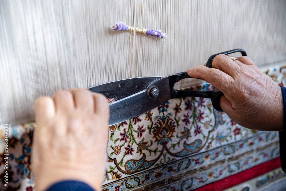 weaving carpet ,a diligent woman makes a traditional carpet by hand ...