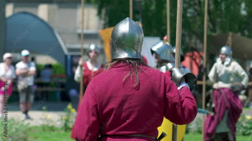 Back of knight holding spear and wearing helmet at pretend medieval ...