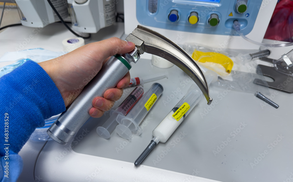 medical professional using airway equipment, mask, laryngoscope, and ...
