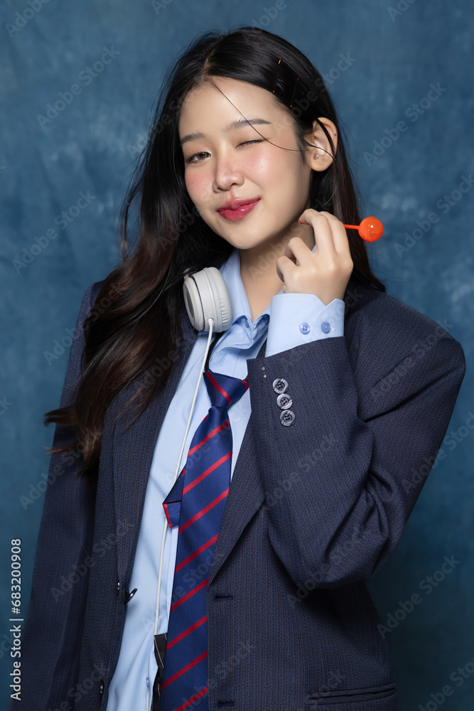 Beautiful Asian woman in school uniform taking a photo of yearbook ...