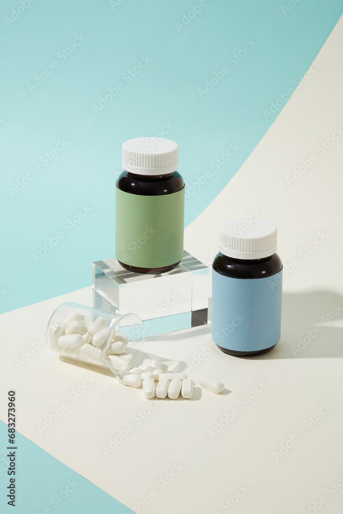 White pills were poured from a transparent laboratory beaker. Two ...