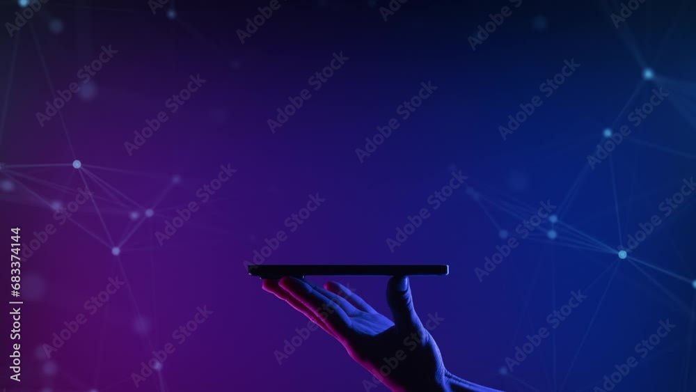 A hand holding smartphone on the neon light background. Mobile ...