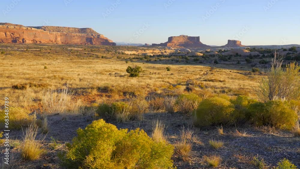 Establishing shot of mountain trail with red rocks background in ...