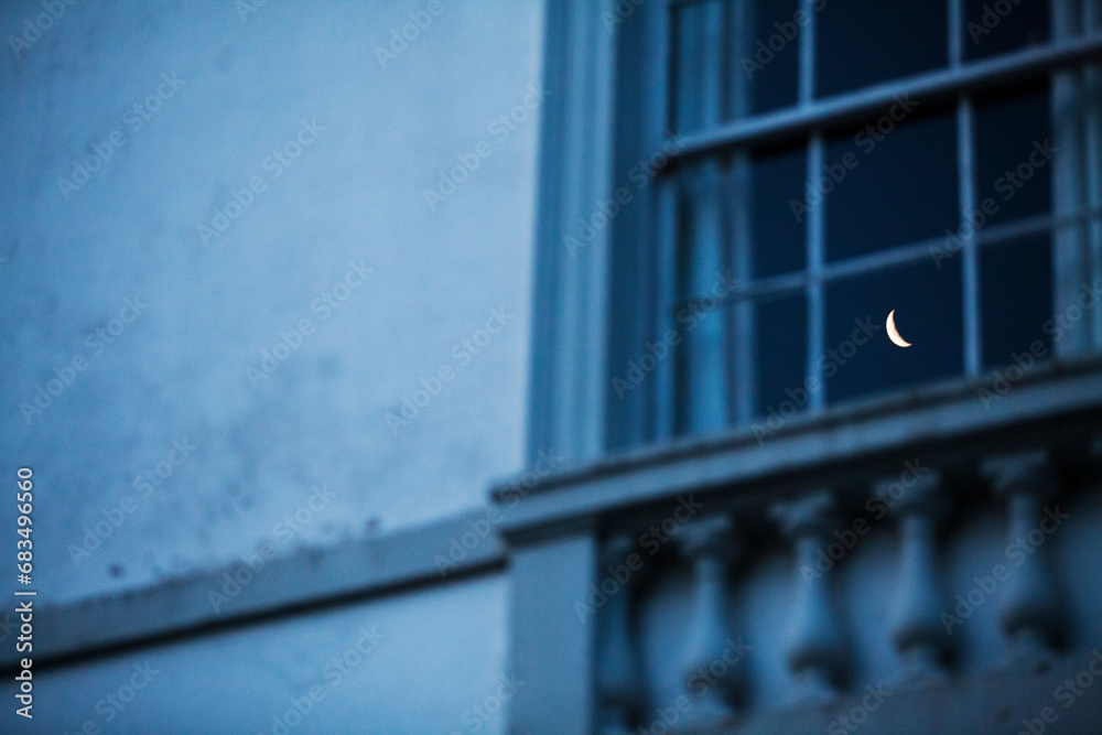 reflection of crescent moon in old fashioned window pane within an old ...