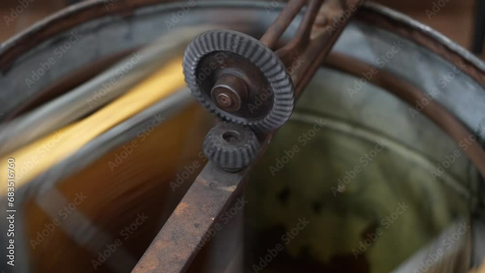 Extraction of honey from honeycombs of nesting frames in honey ...