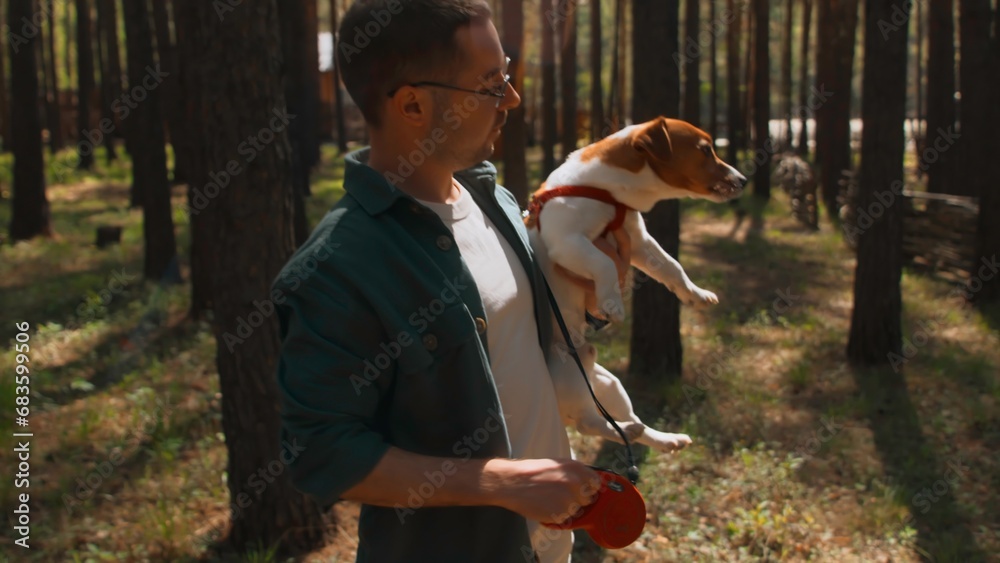 Man picks up dog in arms. Stock footage. Man picks up dog in woods on ...