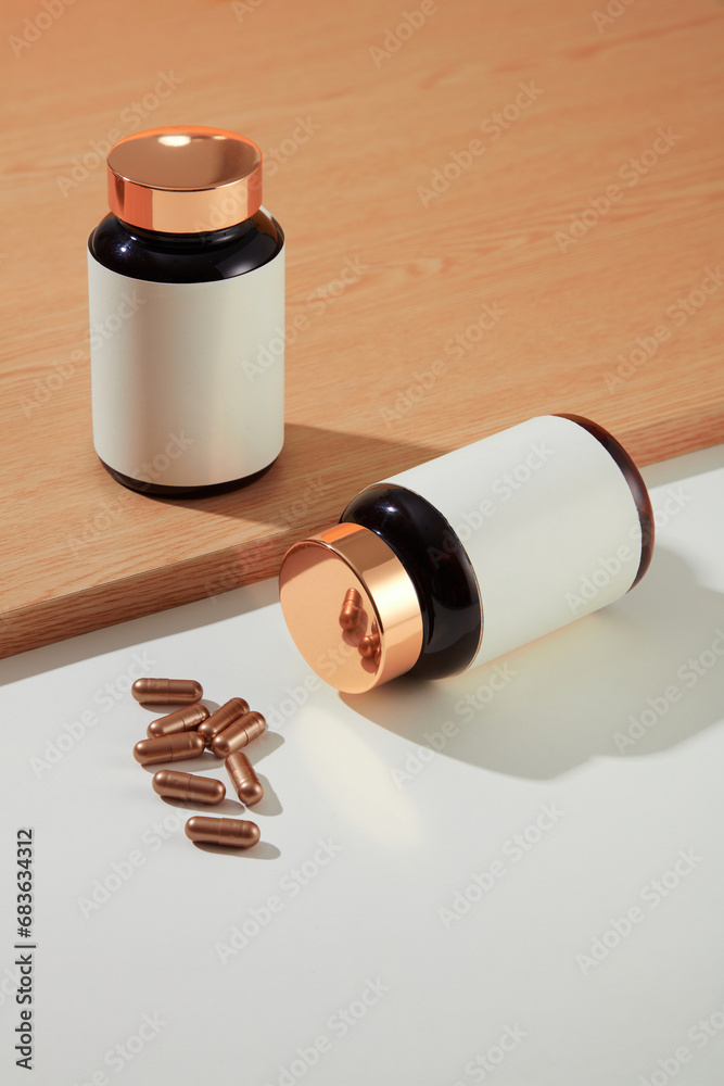 Two white-label medicine bottles are placed on the table with hard ...