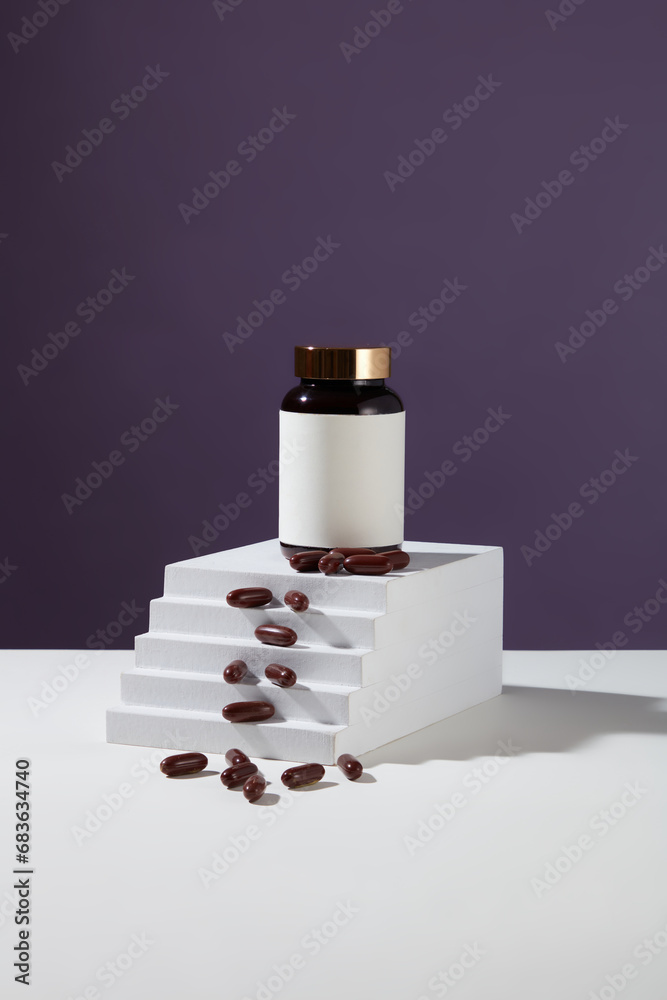An unbranded medicine bottle is placed on a white podium. Brown ...