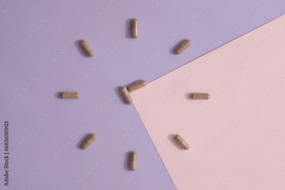 The hard gray capsules are arranged in a clock shape on a purple ...