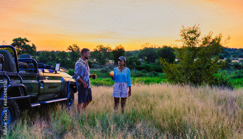 Asian women and European men on safari game drive in South Africa ...