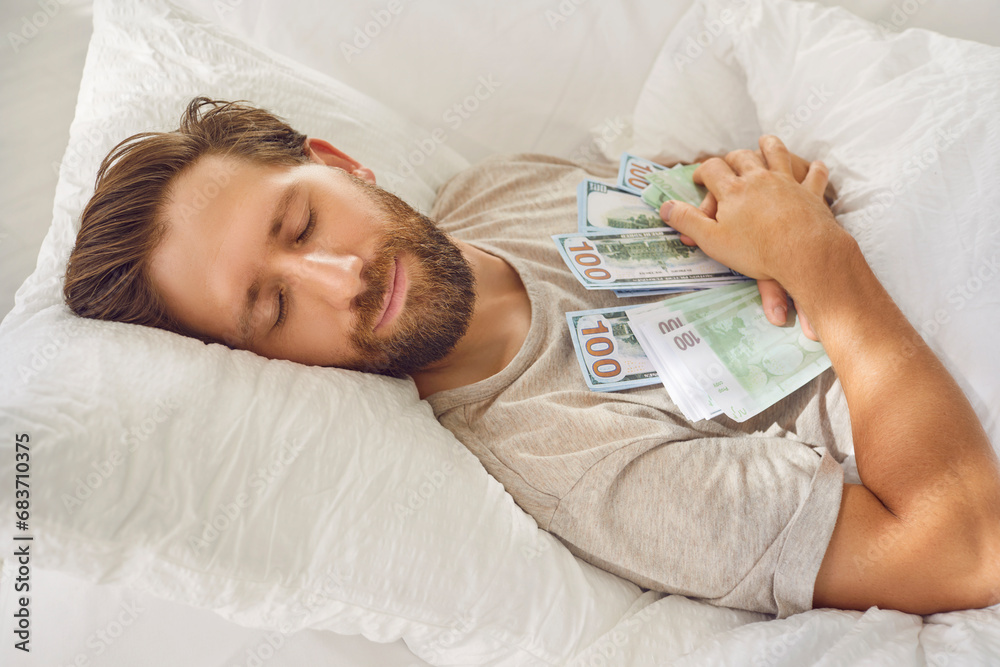 Smiling cheerful sleeping man lying in bed with closed eyes, embracing ...