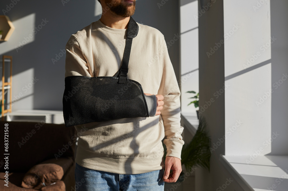 Cropped shot of man with broken arm in plaster cast. Injured man with ...