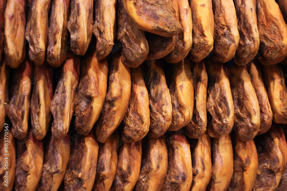 Spanish ham leg. Jamon iberico background. Many legs hanging in market ...